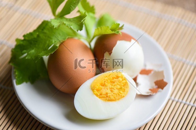 鸡蛋早餐、新鲜去皮鸡蛋菜单食品煮鸡蛋和蛋壳在白盘上装饰着木制背景的叶绿芹菜、鸡蛋烹饪健康饮食概念高清摄影大图-千库网