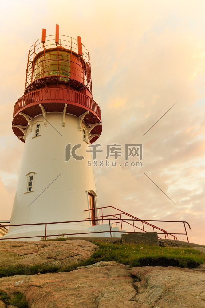 位于岩石海岸边缘的历史悠久的红白色灯塔，南挪威，Lindesnes Fyr 灯塔。高清摄影大图-千库网