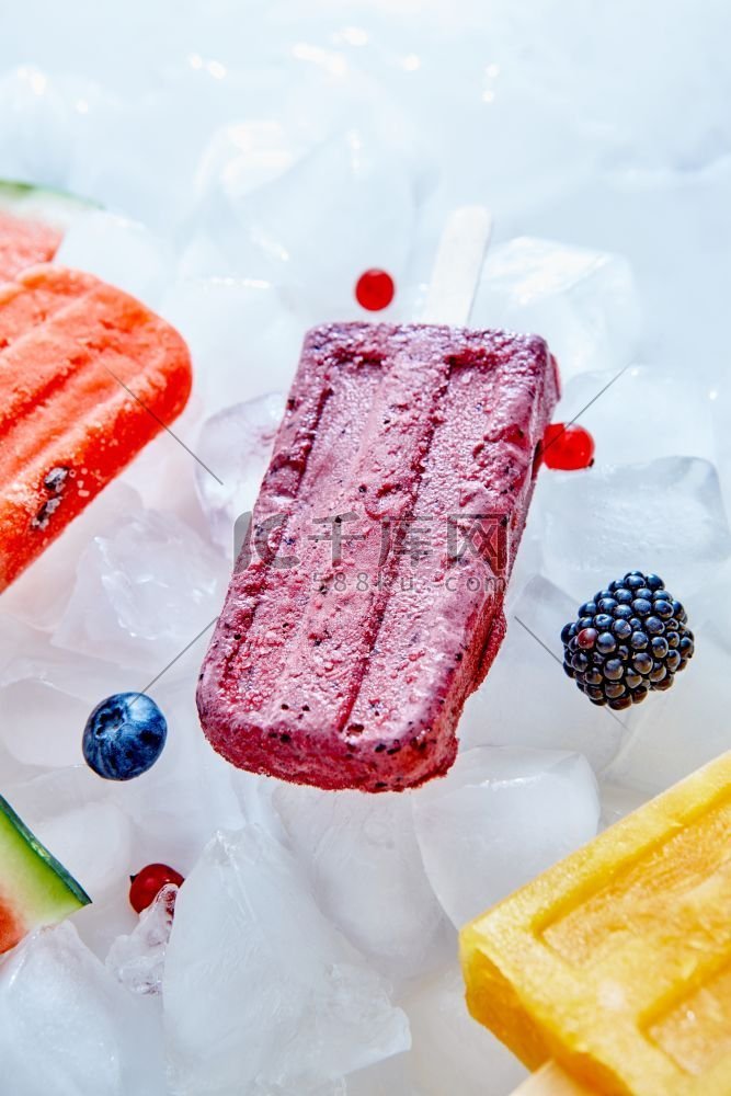 水果冷冻汁放在冰块上，放在一根棍子上，上面有蓝莓、醋栗和黑莓。高清摄影大图-千库网