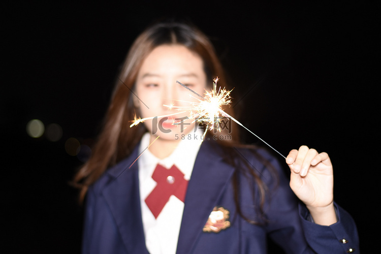 夜晚手持烟花棒的女生高清摄影大图-千库网