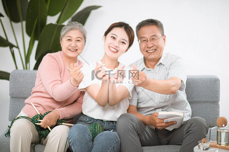 家庭和谐棒棒糖一家三口客厅比心摄影图配图高清摄影大图-千库网