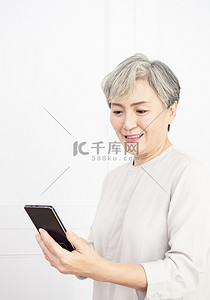 Happy mature senior asian woman holding smartphone using mobile online ...