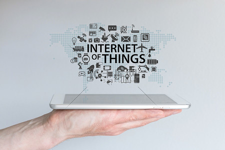 Hand holding tablet or modern smart phone. Internet of things (IOT ...