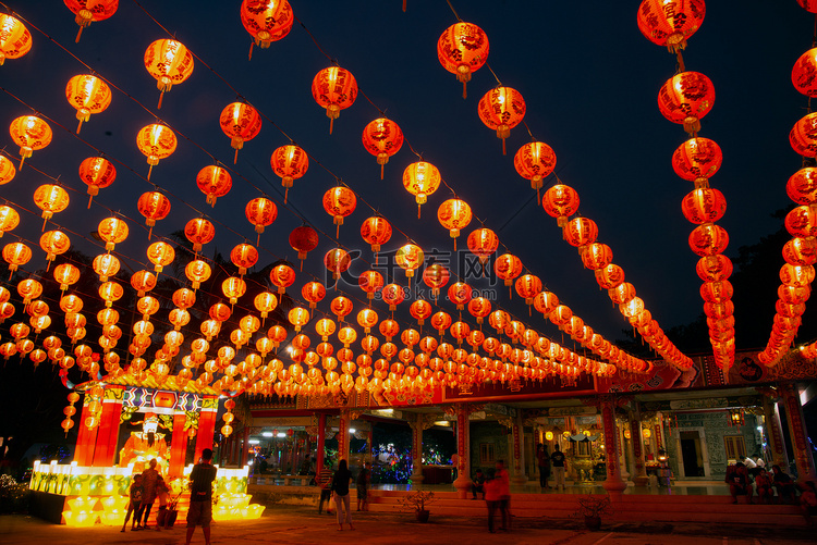 Red lanterns hanging in the black sky and god lamp at night in the ...