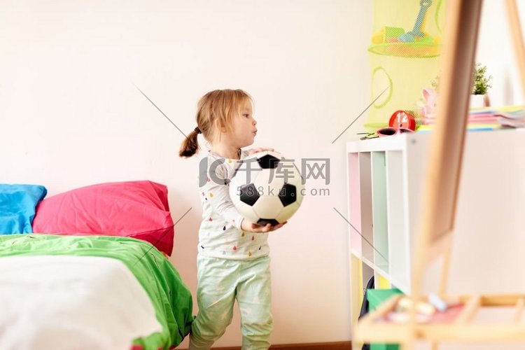 童年、休闲和人的概念-快乐的小女孩在家里玩足球。快乐的小女孩在家里玩足球高清摄影大图-千库网