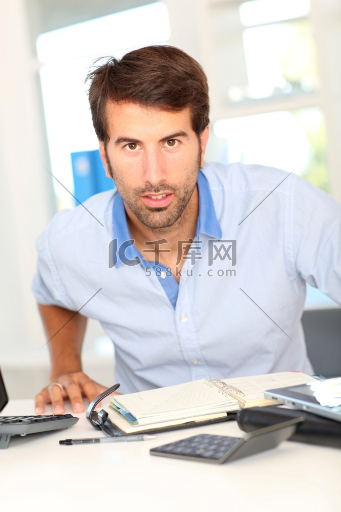坐在办公桌前的办公室职员高清摄影大图-千库网