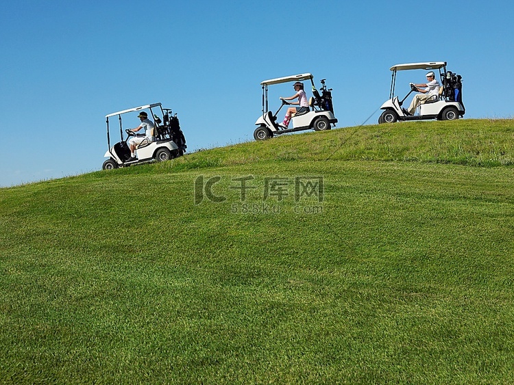 高尔夫球手驾驶球车高清摄影大图-千库网