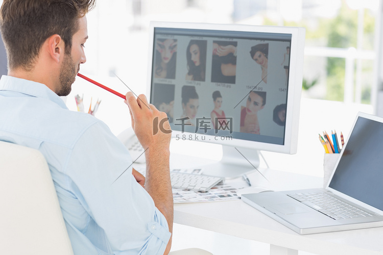 在办公室用电脑工作的男性照片编辑高清摄影大图-千库网