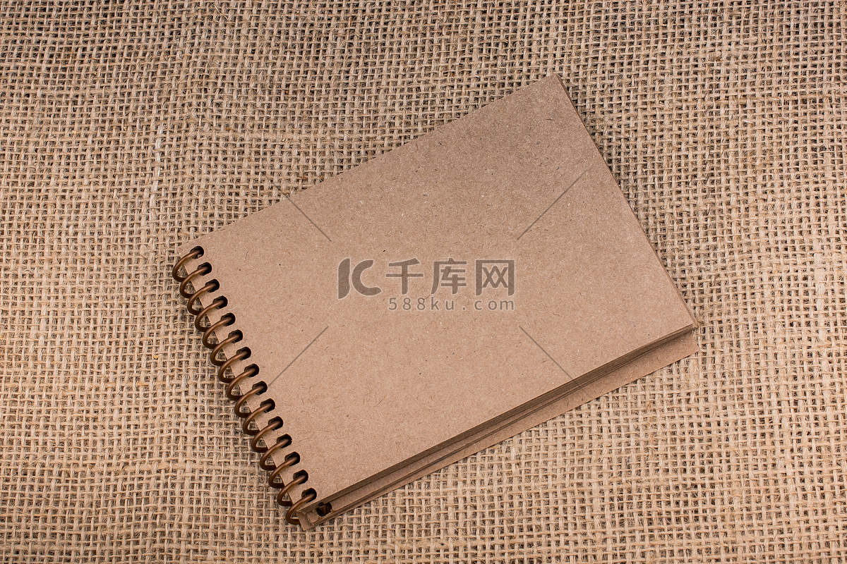 亚麻帆布上的棕色笔记本高清摄影大图-千库网