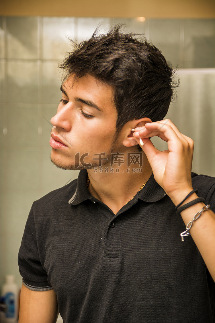 年轻人用棉签清洁耳朵高清摄影大图-千库网