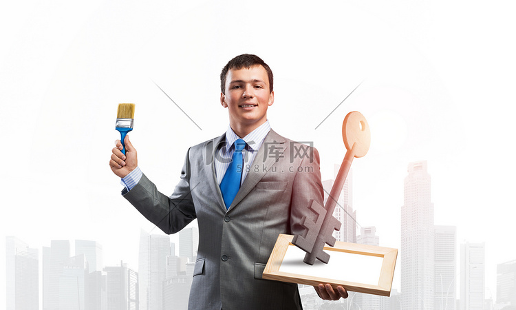 拿着画笔的创造性的商人画家高清摄影大图-千库网