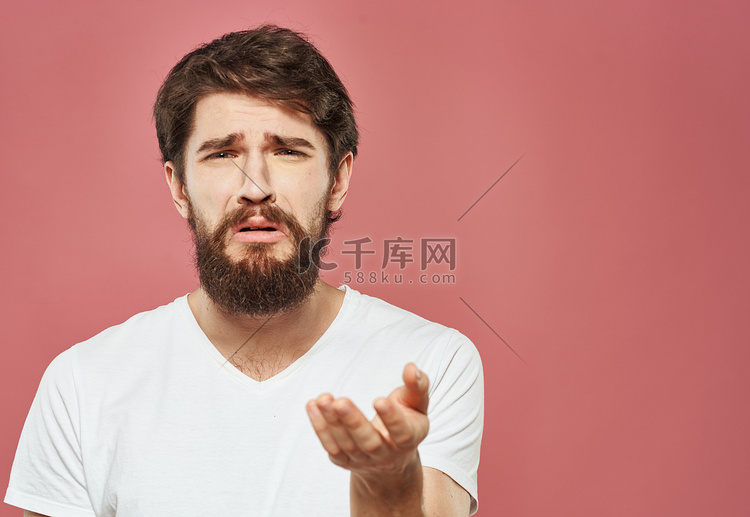 粉红色背景情绪模型裁剪视图中的男人困惑地看着悲伤的脸高清摄影大图-千库网