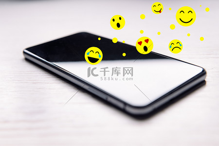从白桌上的手机中发出的表情符号高清摄影大图-千库网