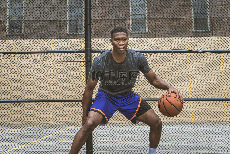 Afro-american basketball player training on a court in New York ...