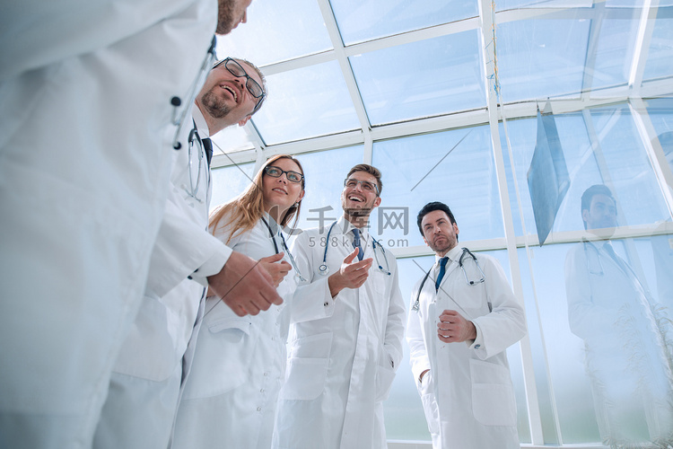 through the glass. group of doctors discussing current tasks高清摄影大图-千库网