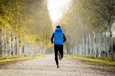 sport man running outdoors in off road trail ground with trees under ...