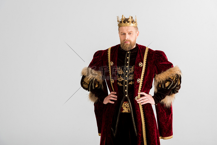handsome king with crown with hands on hips looking at camera isolated ...